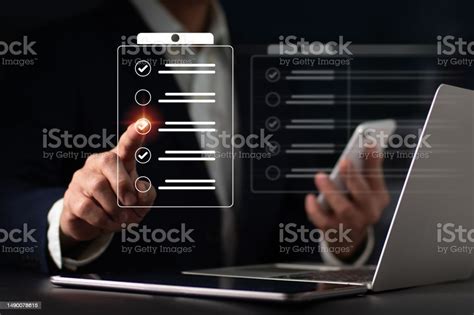 비즈니스 성공을 추적하기 위한 개념으로 스마트폰을 사용하는 사업가를 보여주는 디지털 양식 체크리스트 온라인 설문조사 완료 파란색 배경 45 49세에 대한 스톡 사진 및 기타