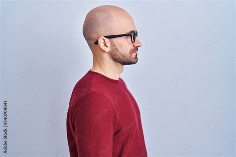 Babe Bald Man With Beard Standing Over White Background Wearing Glasses Looking To Side Relax