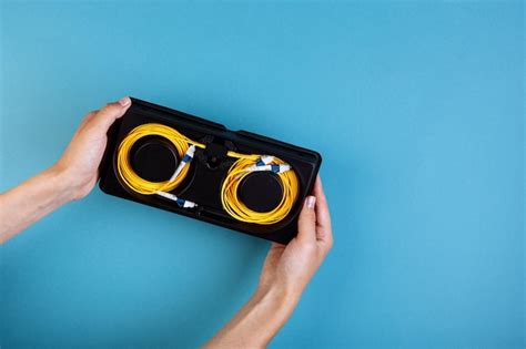 Premium Photo Woman Hands Take Blue Variable Optical Attenuator On Blue Background