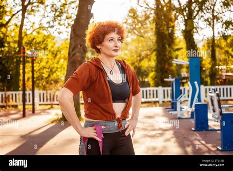 Adult Caucasian Woman With Makeup And Ginger Curly Hair Posing In