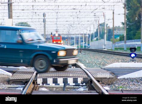 Railway Crossing Through Which An Old Passenger Car Passes While