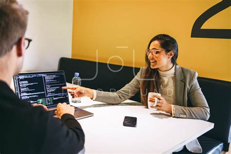 tech colleagues discussing software design and coding in a coworking o