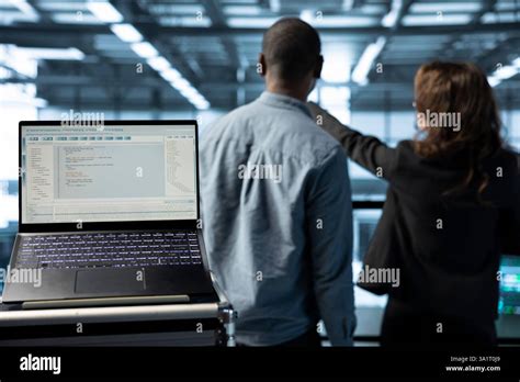 Focus On Lines Of Code On Laptop Screen Used By Data Center Engineers