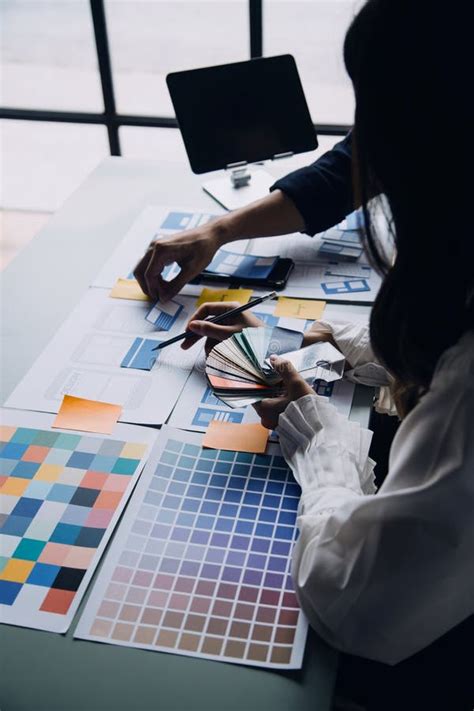 Close Up Ux Developer And Ui Designer Brainstorming About Mobile App Interface Wireframe Design