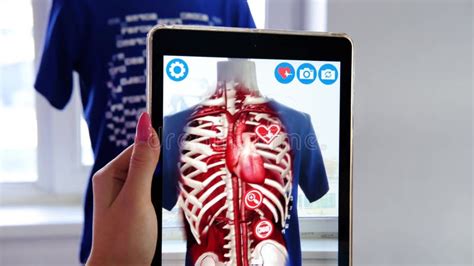 teacher interacts with augmented reality human anatomy on tablet in