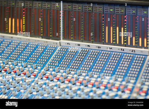 A Close Up View Of A Professional Audio Mixing Console With Illuminated