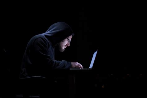 Hacker Using Laptop Computer While Working In Dark Office Stock Photo At Vecteezy