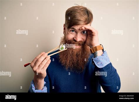 Redhead Irish Man With Beard Eating Green Maki Sushi Using Chopsticks