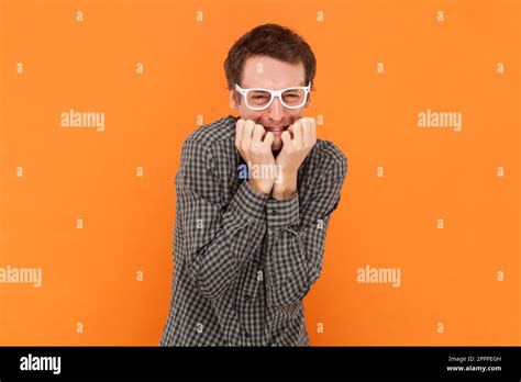 Anxious Puzzled Man Nerd Bites Finger Nails Stands Insecure And Nervous Feels Uncomfortable