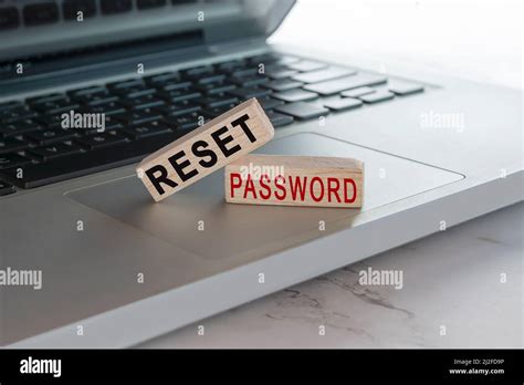 Reset Password Text On Wooden Block Cube Placed On Laptop Or Notebook