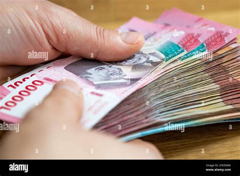 Indonesia Money Big Bundle Of Banknotes In Hand 100000 Thousand