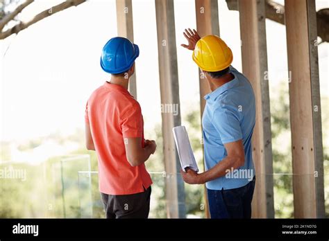 I Could See A Big Window Over Here Two Architects Assessing The Structure They Are Building