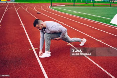 카딩 달리기 전에 운동을 하는 유연한 몸을 위한 진지한 강한 남성 러너 트렌드 다리 피트니스 목표에 도달하는 트렌디한 운동복을