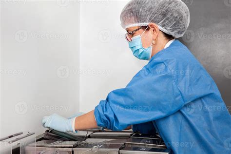 Female Scientist Staining Microscope Slides For Cytology Studies In The