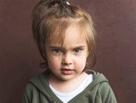 Premium Photo Portrait Of Cute Girl Standing Against Wall