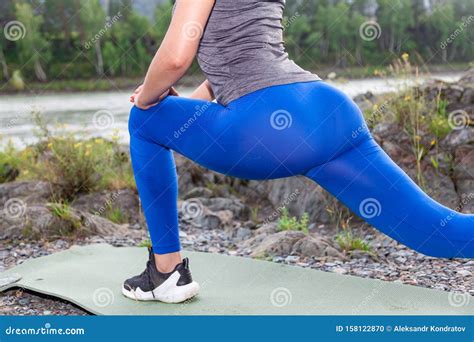 Close Up On A Tight Booty Of Pretty Woman While She Is Doing Stretching