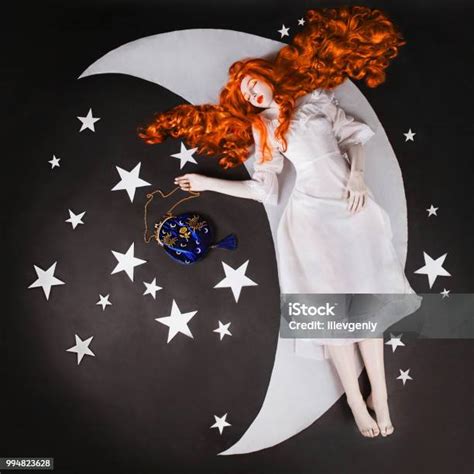 달과 별 검은 배경에 흰색 드레스에 매우 긴 머리를 가진 젊은 요정 여자 창백한 피부와 아름 다운 여자입니다 달에 르네상스 요정