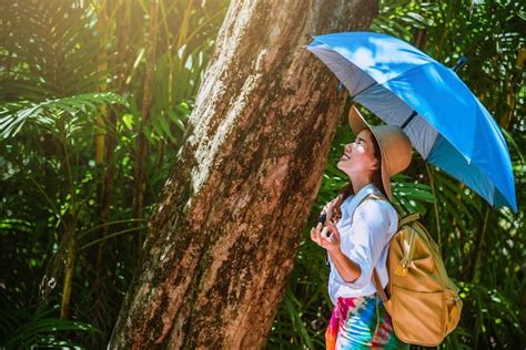Premium Photo Side View Of Woman Standing On Tree Trunk