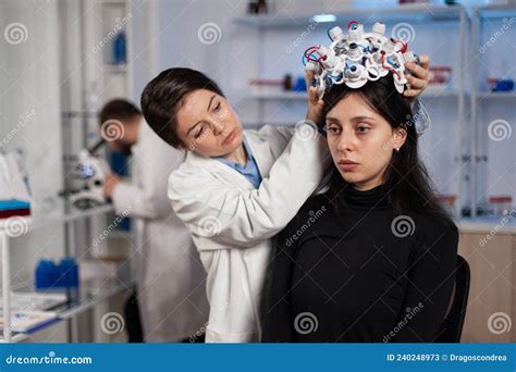 Scientist Woman Putting Eeg Headset On Woman Patient Head During Neurology Experiment Stock