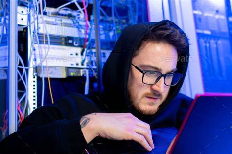 Concentrated Hooded Hacker In Data Center Hacking Software System Vulnerable Cyber Security