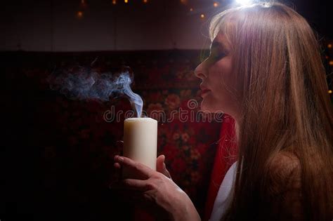Middle Aged Beautiful Woman Holds Aromatic Candle In Hands
