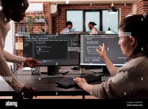 Multi Ethnic Tech Enginners Developing Html Code And Cloud Computing In It Development Agency