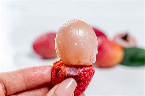 Fresh Cut Lychee Fruit With Big Nut And Whole Lychees On White