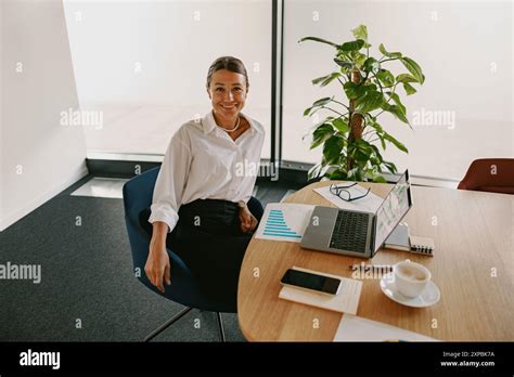 A Professional Woman Engaging In Work Activities Within A Modern Office Environment Setting