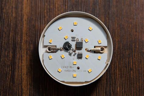 Premium Photo Disassembled Led Lamp On Dark Wooden Background