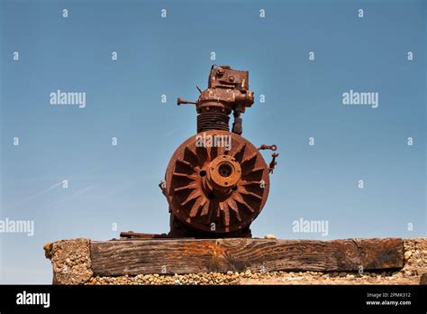 Rusty Metal Cog Wheel On A Wooden And Concrete Base Stock Photo Alamy