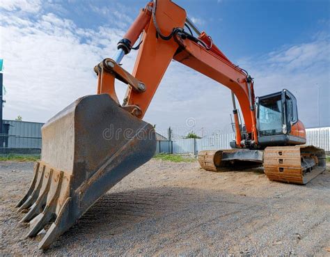 Backhoe Bucket Large Orange Backhoe Parked At A Construction Site