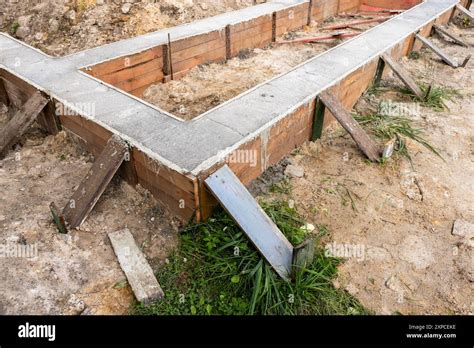 Freshly Laid Concrete Foundation In Wooden Formwork Rural House