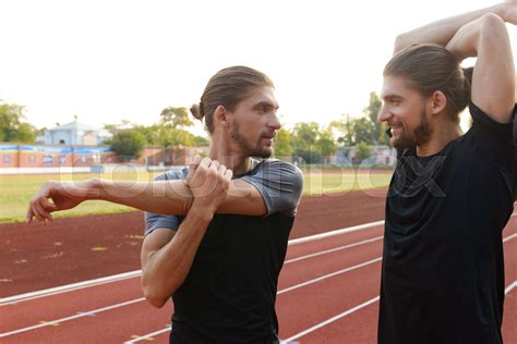 Handsome Young Two Twins Brothers Make Stretching Exercises Outdoors Stock Image Colourbox