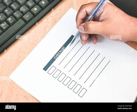 Checklist Concept Paper With Checkbox And A Hand Holding A Pen Stock