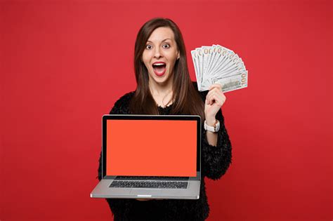 빨간색 배경에 고립 달러 지폐 현금 돈에 돈의 빈 빈 화면 팬 노트북 Pc 컴퓨터를 들고 흥분 여자 사람들은 진심으로 감정 라이프 스타일 개념입니다 복사 공간을 모의 합니다