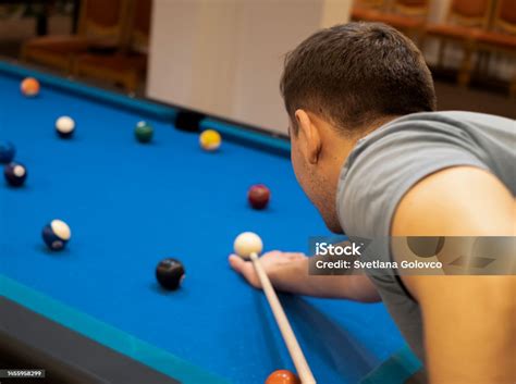 Man Holding Hand On Pool Table Playing Snooker Or Getting Ready To