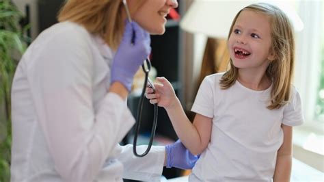 Una Niña Riendo En Una Clínica De Un Médico Un Primer Examen Médico