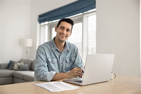 Man Sits At Desk With Laptop Smiling Looking At Camera Stock Image Image Of Business Online