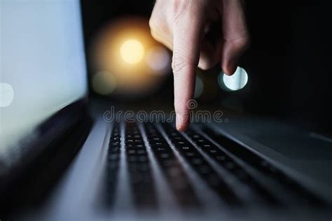 One Key At A Time An Unrecognizable Computer Hacker Using A Laptop Late At Night Stock Image