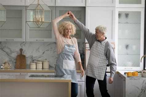 Happy Lively Older Couple Dancing In Cozy Kitchen Stock Photo Image