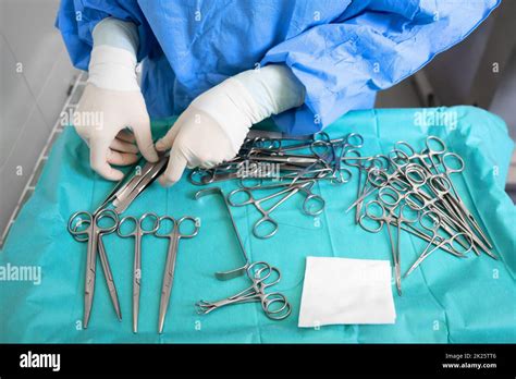Multiple Surgery Instruments On Blue Table Above View Surgeon Take Surgical Tools From Table