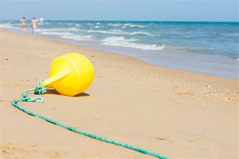 Premium Photo Buoy And Rope Dividing Area On Beach