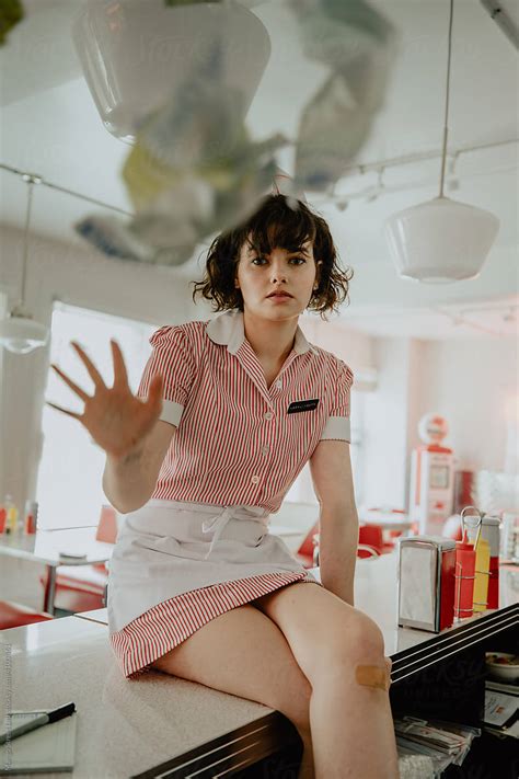 1950s Diner Waitress Sitting On Countertop By Stocksy Contributor Mango Street Lab Stocksy