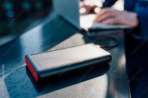 Solar Battery Charger Connected To Laptop Being Used By Businessman Stock Photo Adobe Stock