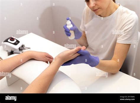 Nails Master Spraying Sanitizing Clients Hands By Antiseptic From
