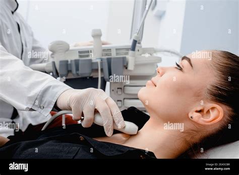 Doctor In Diagnostic Center Making Ultrasound Thyroid Gland Test Stock