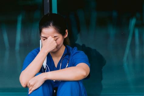 premium photo stressed tired healthcare worker sitting on floor