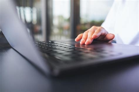 Premium Photo Closeup Image Of A Woman Working And Touching On Laptop Touchpad On The Table
