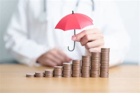 Doctor With Coins Money Stack Growing With Umbrella Cover Money Saving Health Insurance