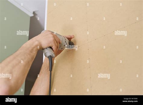 Closeup Of Hand Worker Doing Furniture Assembling Kitchen With